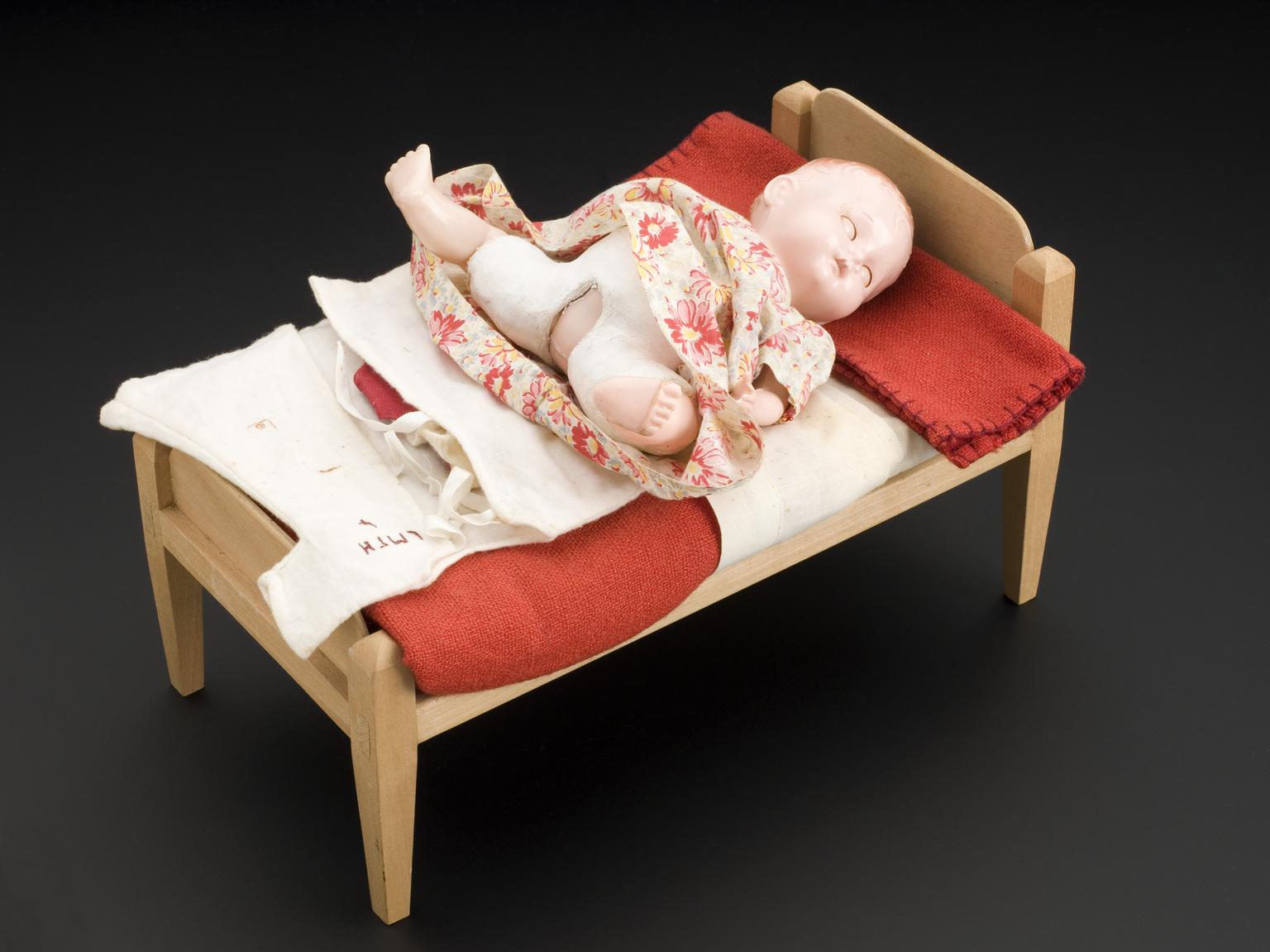 Doll lying in bed to demonstrate medical treatment to children, England ...