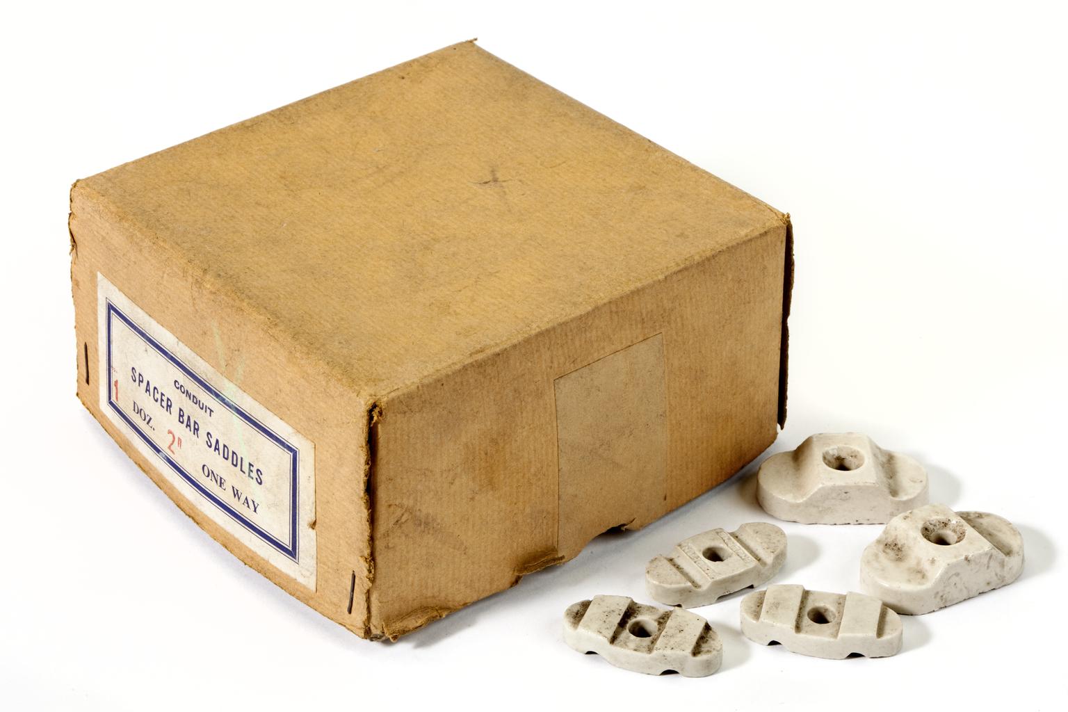 Porcelain cleats in a conduit spacer bar saddles box | Science Museum ...