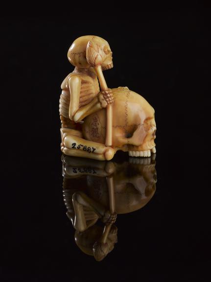 Netsuke in form of skeleton sitting behind skull | Science Museum Group ...