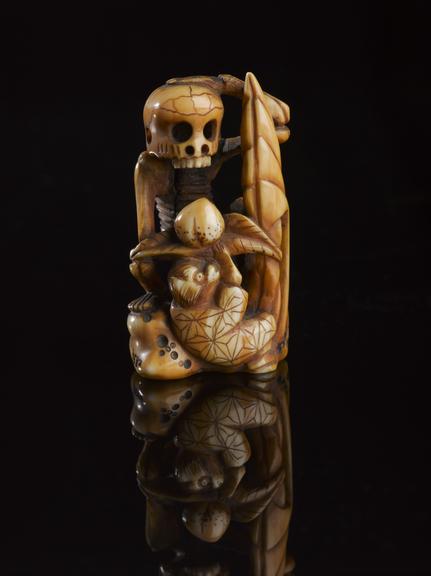 Netsuke in form of skeleton with Tanuki the Japanese raccoon dog ...