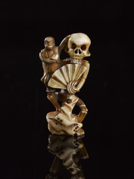 Netsuke in form of skeleton holding fan and Tanuki the badger | Science ...