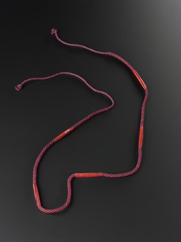 Long silk cord with 5 rolled sheets of lead incorporated into it ...