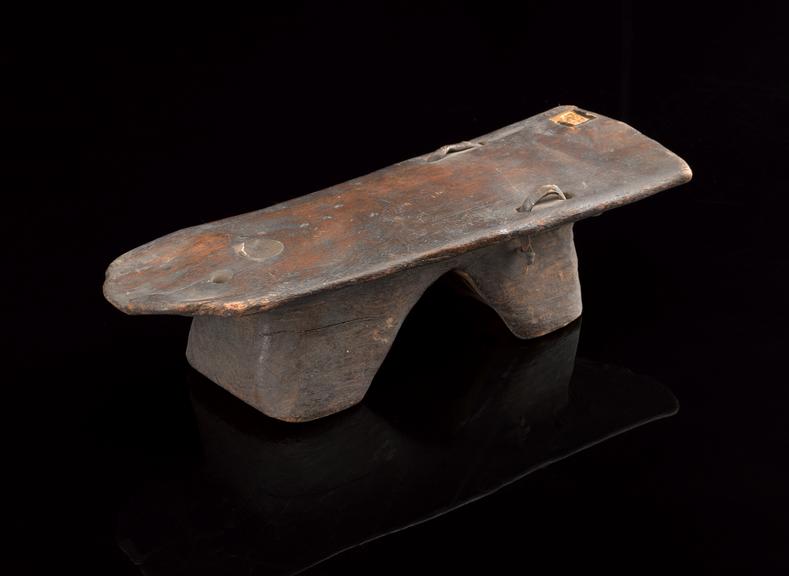 Wooden patten made from single piece of wood with holes for securing ...