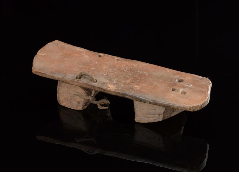 Patten carved from single piece of wood with holes for securing leather ...