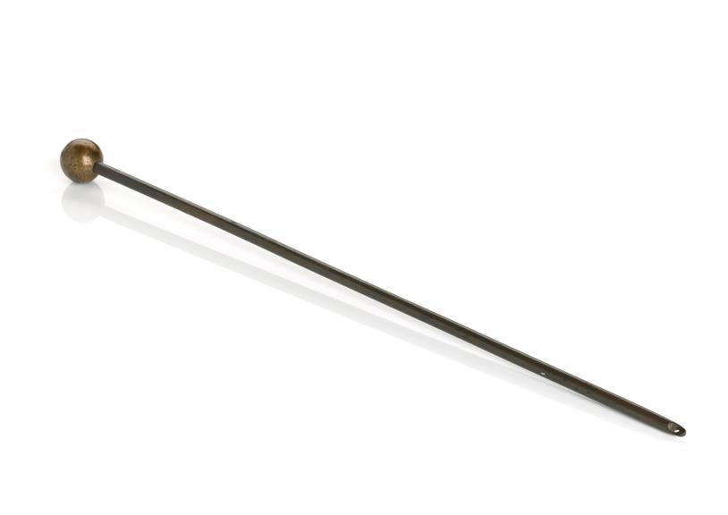 Metal rod with a ball at one end and the other end flattened and ...