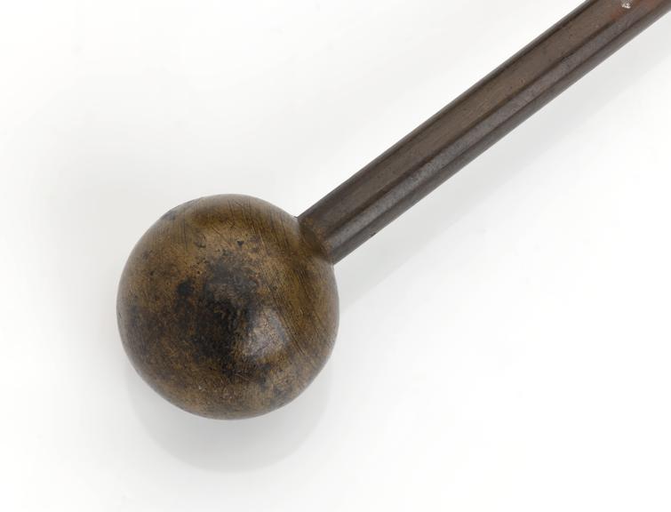 Metal rod with a ball at one end and the other end flattened and ...
