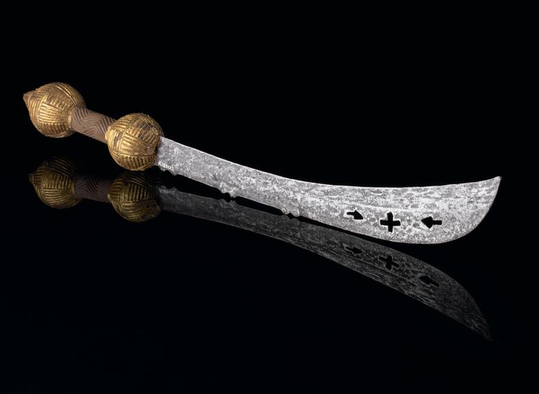 Curved steel ceremonial sword with wooden handle decorated with gold ...