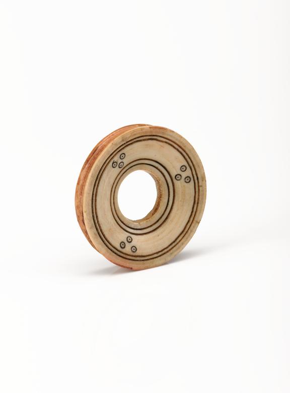 Disk-shaped ivory ear plug | Science Museum Group Collection