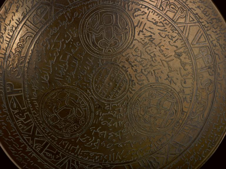 Brass divination bowl engraved with symbols and Arabic script | Science ...