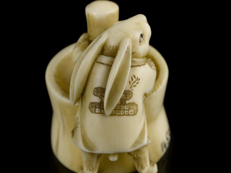 Netsuke in form of rabbit grinding with mortar and pestle | Science ...