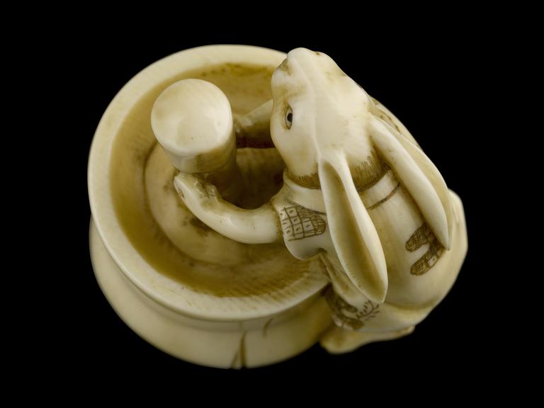 Netsuke in form of rabbit grinding with mortar and pestle | Science ...