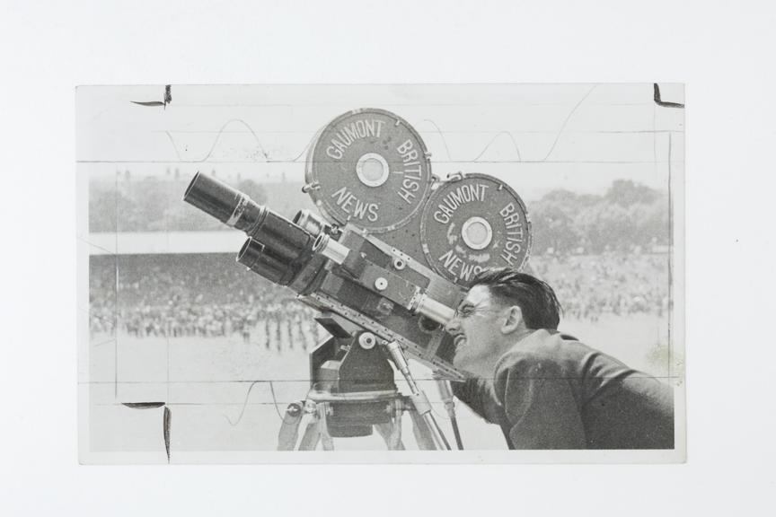 Photograph showing a news cameraman using a Gaumont British News camera ...