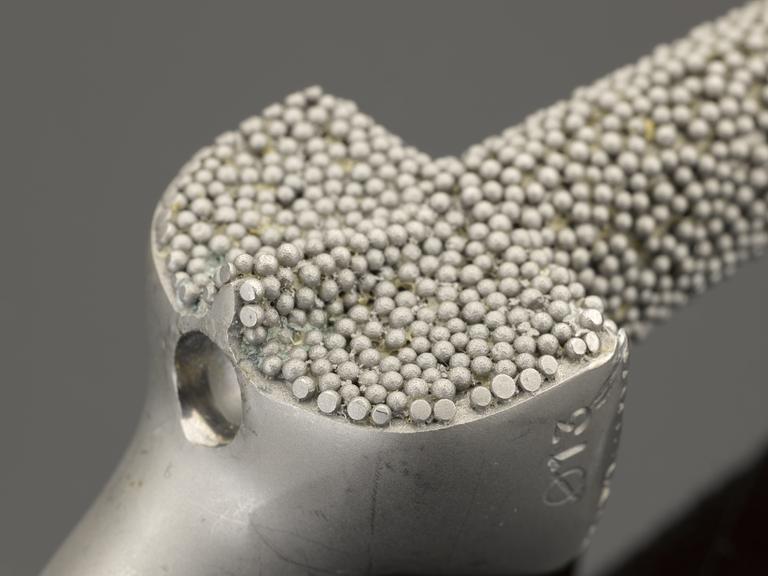 Modular hip prosthesis with textured femoral stem to aid bone grafting ...