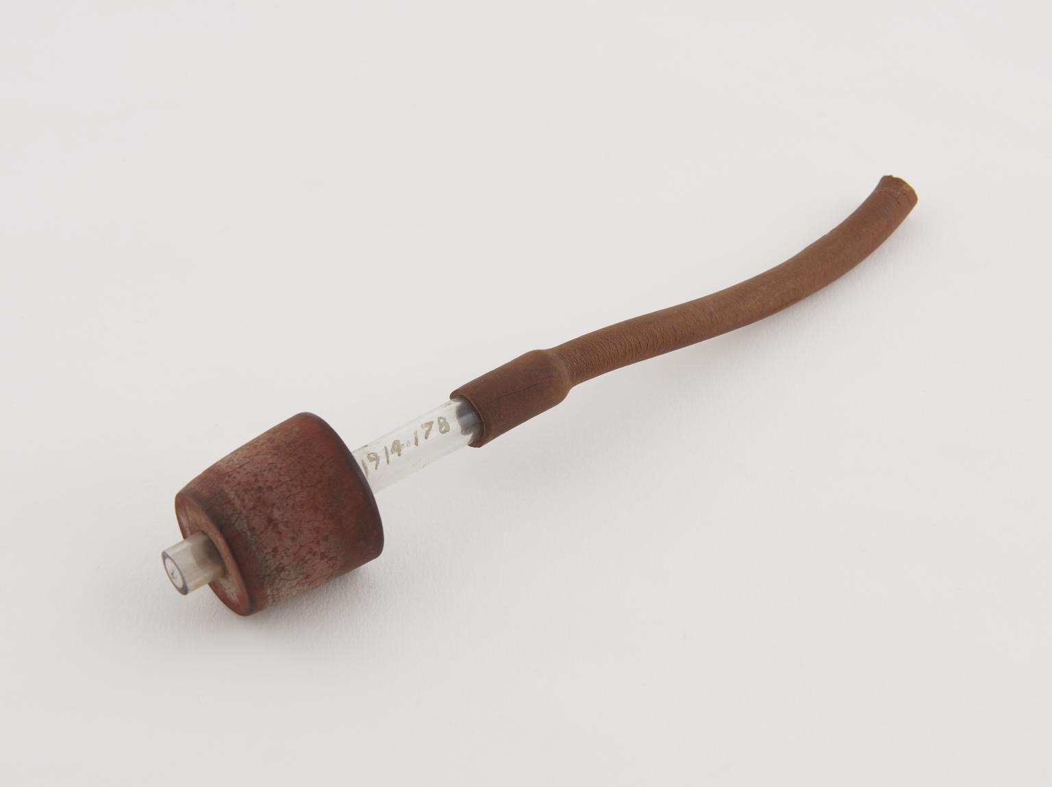 Glass pipe, with cork bottle stopper at one end and rubber hose ...