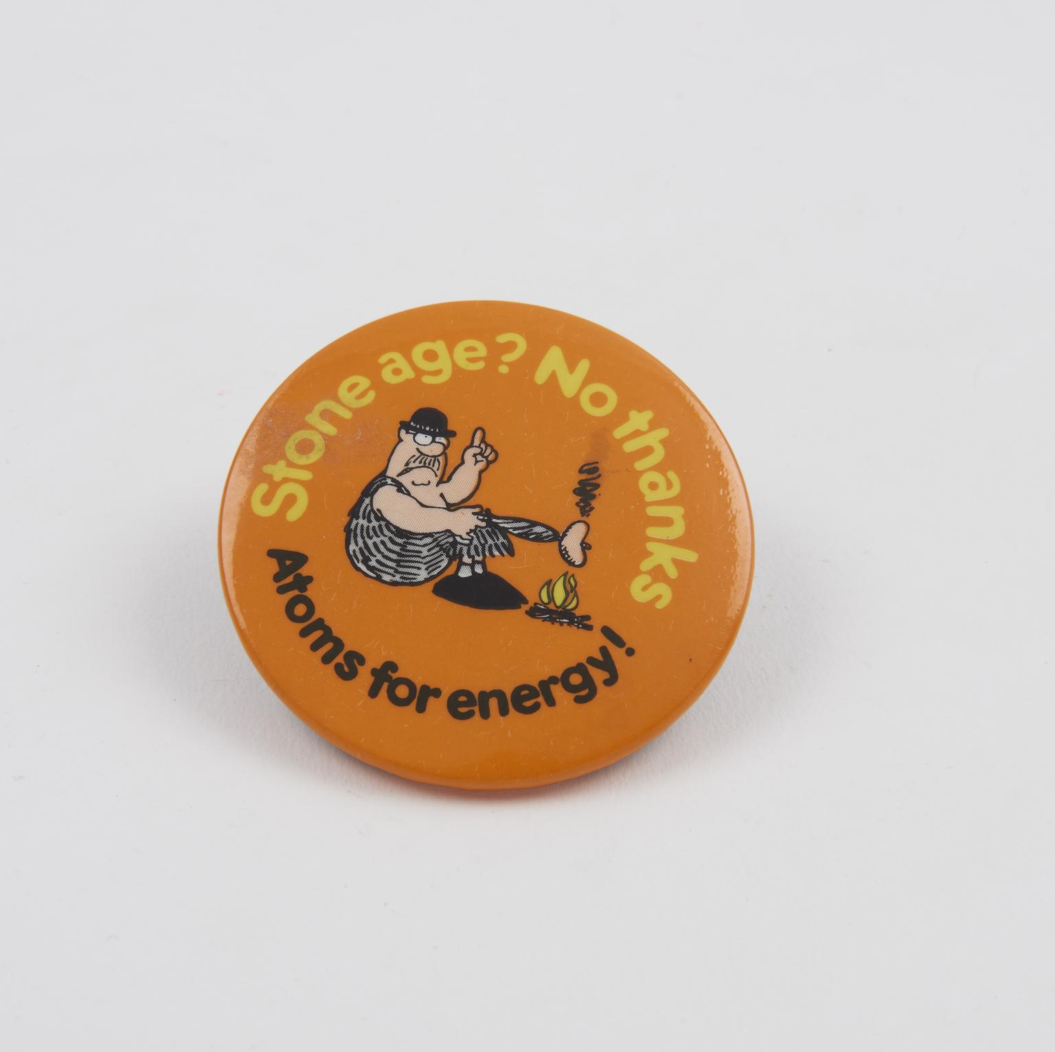 Tin badge, with a text "Stone Age? No Thanks Atoms for Energy ...