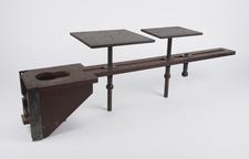 Open ended box attached to slotted beam with three adjustable stands ...