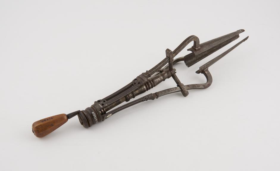 Vaginal speculum with wooden handle | Science Museum Group Collection