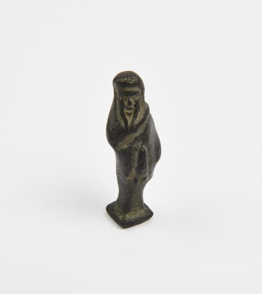 Solid bronze amulet in form of draped figure with priapic organ ...