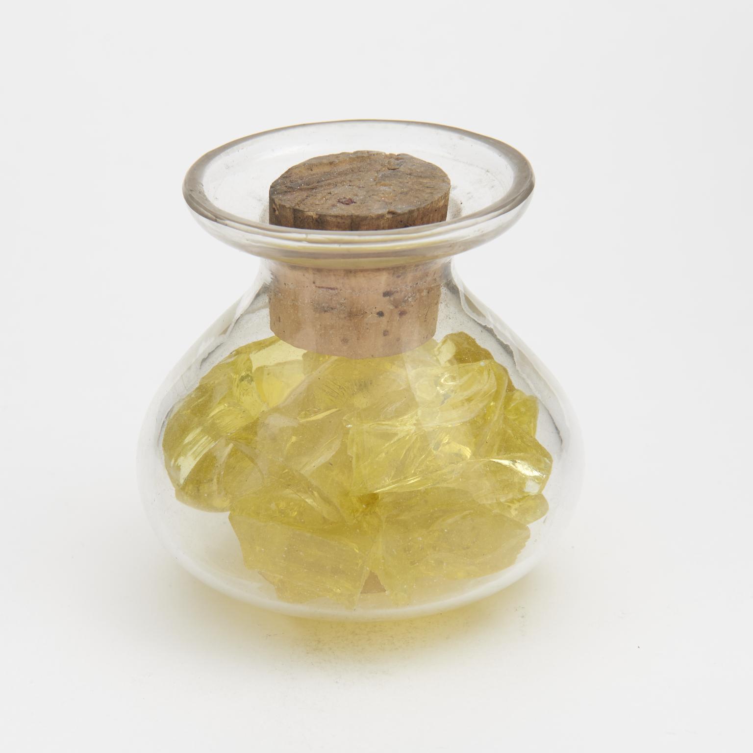Sample bottle containing yellow fragments | Science Museum Group Collection
