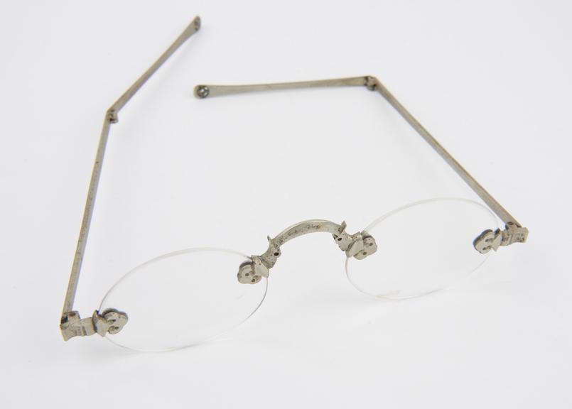 Chinese spectacles with rimless oval convex lenses and two-piece metal ...