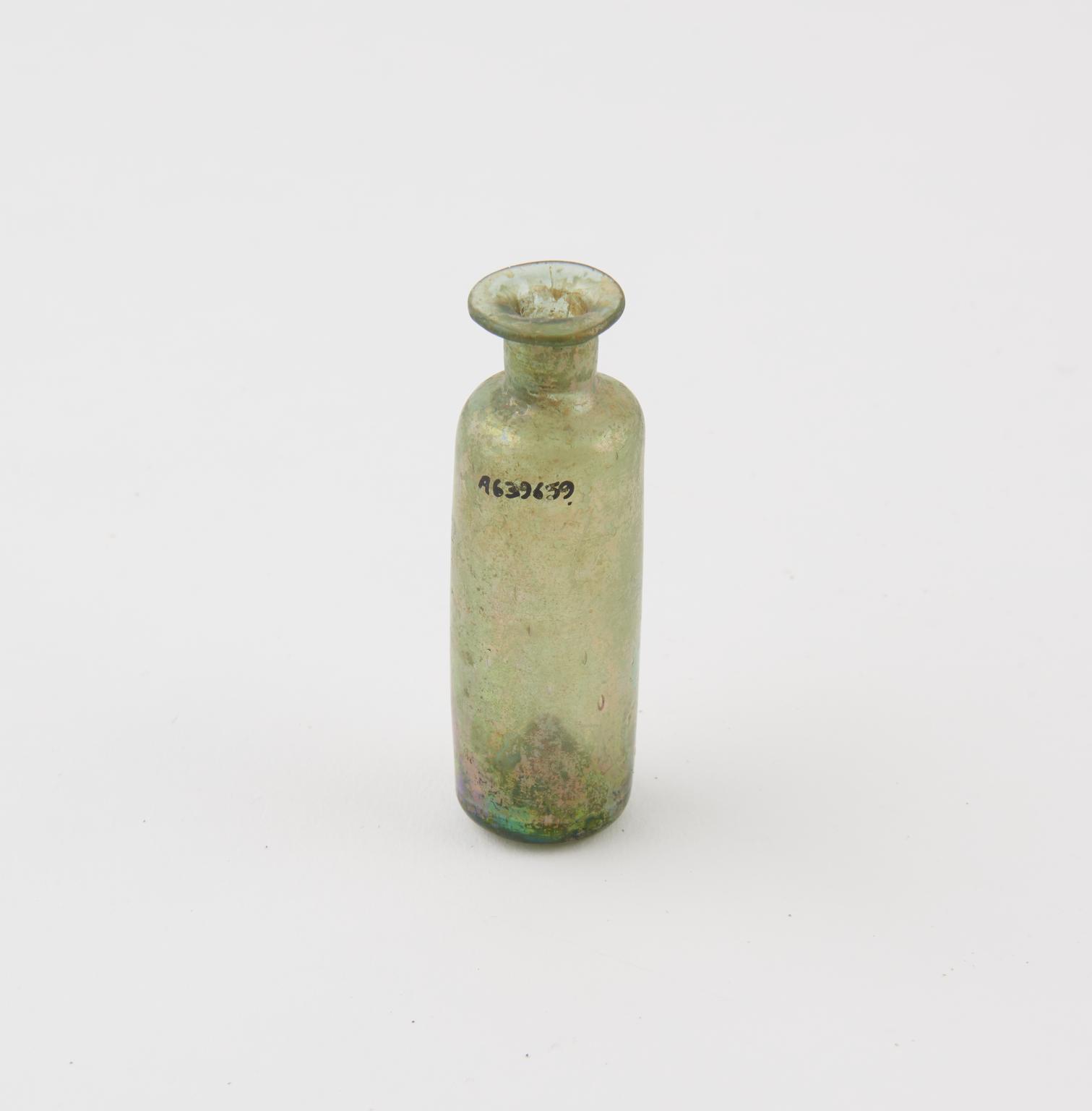 18 iridescent green glass bottles, cylindrical, handblown, with pontil ...