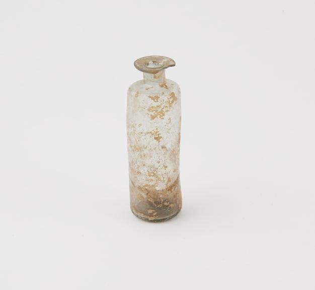 Cylindrical iridescent white glass bottle | Science Museum Group Collection