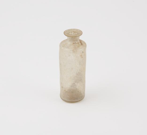 Cylindrical iridescent green glass bottle | Science Museum Group Collection