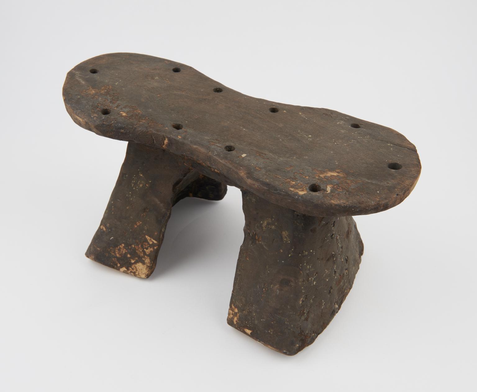 Light wooden patten made from one piece of wood with holes for securing ...