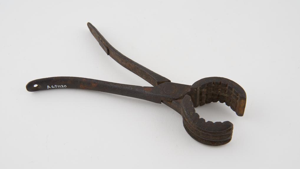 Iron cork compressor in the form of a pair of pliers with a jaws ...