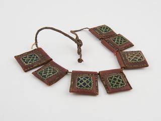 7 red leather amulet cases threaded onto thin leather necklace ...