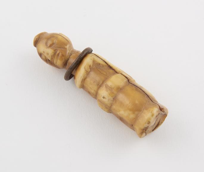 Carved ivory statue representing ancestral female figurine wearing an ...