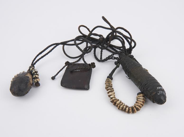 Three amulet cases threaded onto plaited leather thongs | Science ...