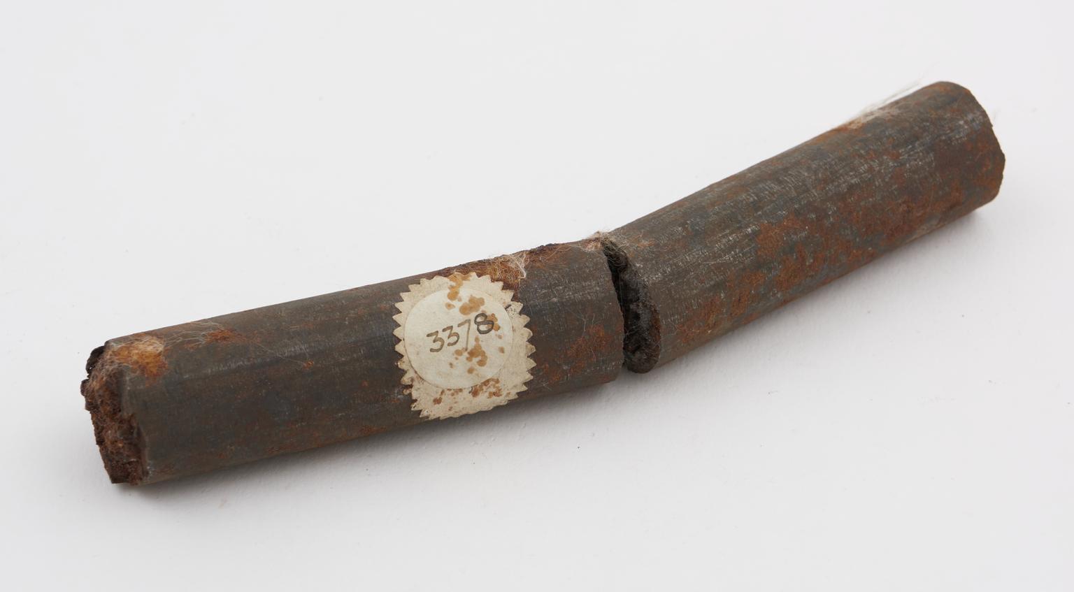 Two pieces of rivet iron, one bent and broken, the other cut and ...