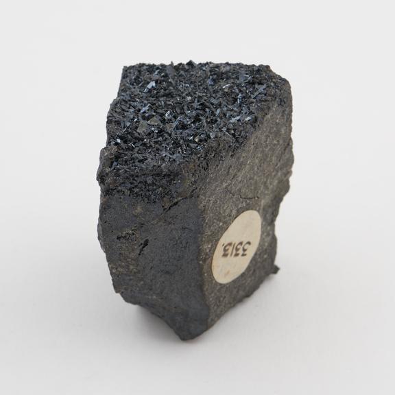 Compact finery-slag, with a surface of small rhombic crystals referred ...