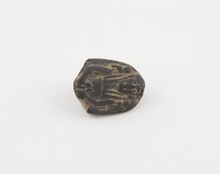 Amulet depicting head and shoulders of female and phallus and testicles ...
