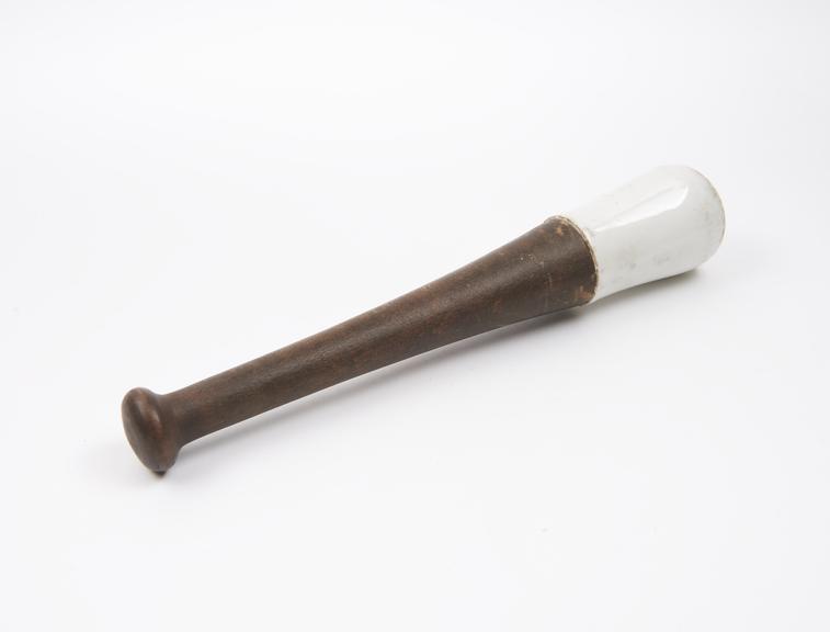 Pestle of pottery with wooden handle | Science Museum Group Collection