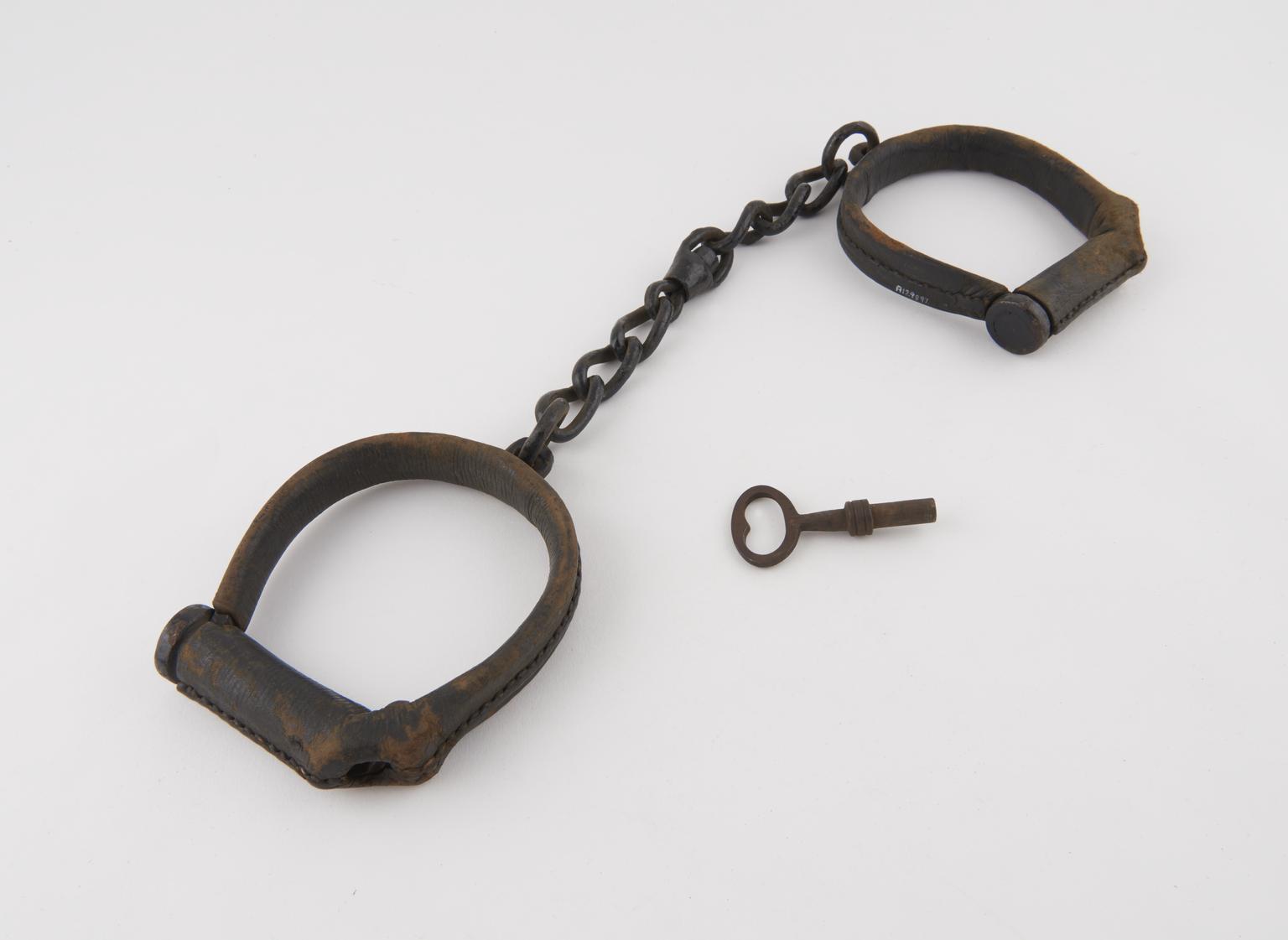Leg irons, with leather padded cuffs | Science Museum Group Collection