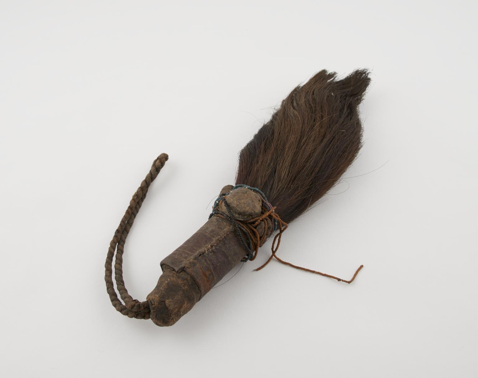 Animal hair fly-whisk in leather handle with looped leather sling and ...
