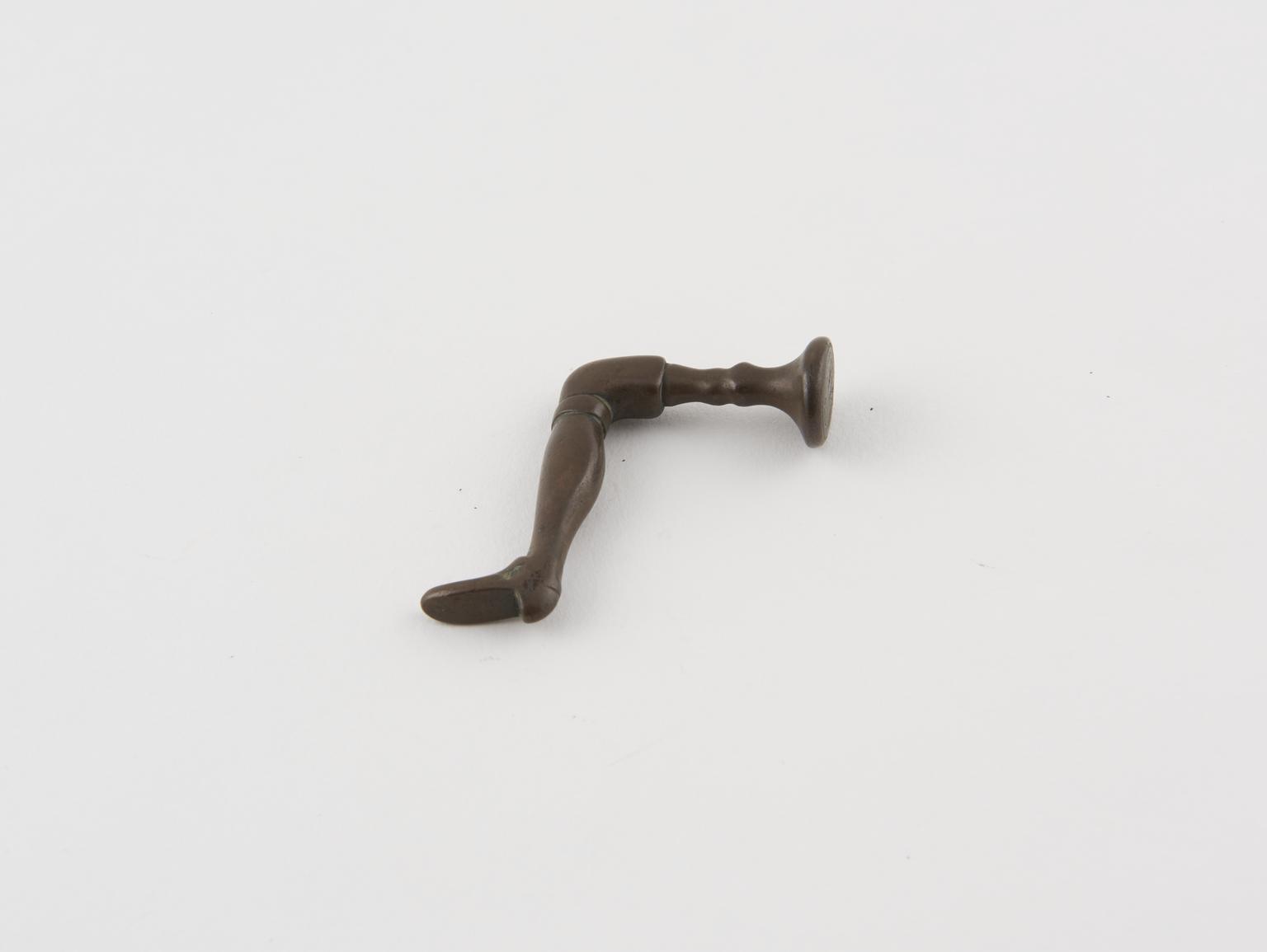 Copper or bronze pipe tamper in form of human leg | Science Museum ...