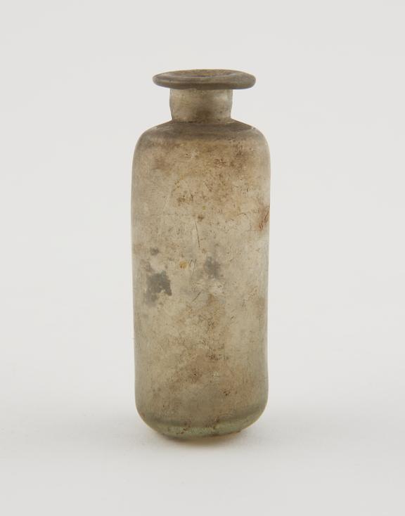 Glass bottle, cylindrical, weathered | Science Museum Group Collection
