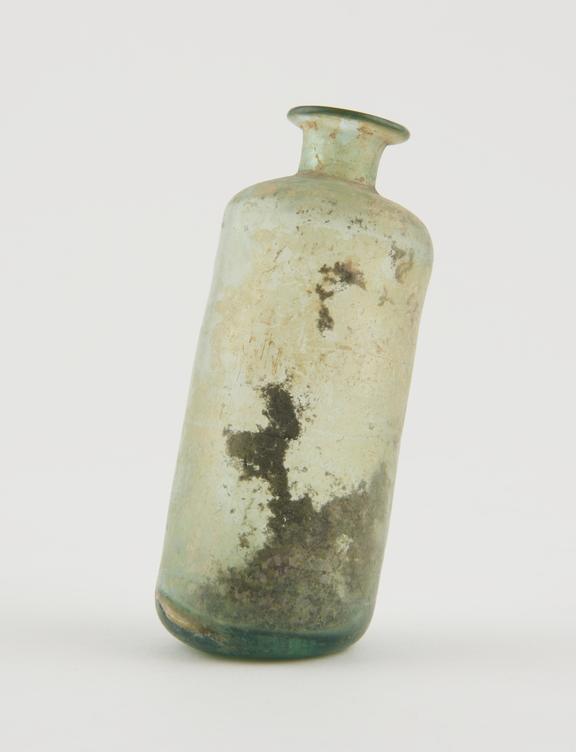 Iridescent cylindrical green glass bottle with pontil mark | Science ...