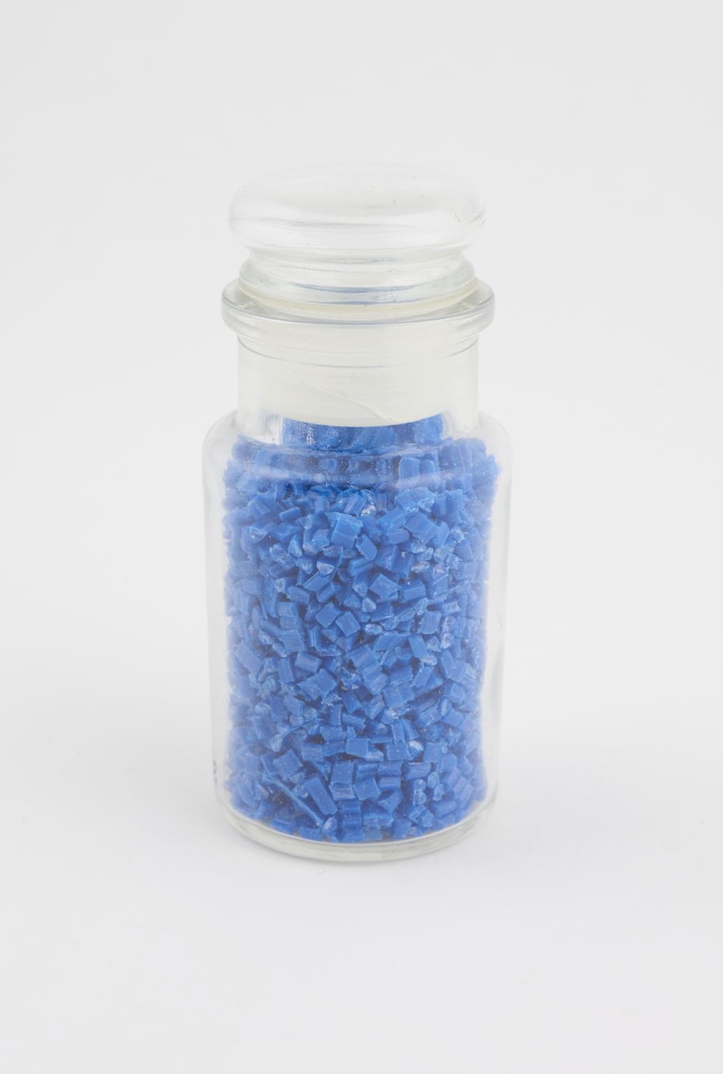 Bottles containing blue and white polystyrene beads and moulding ...