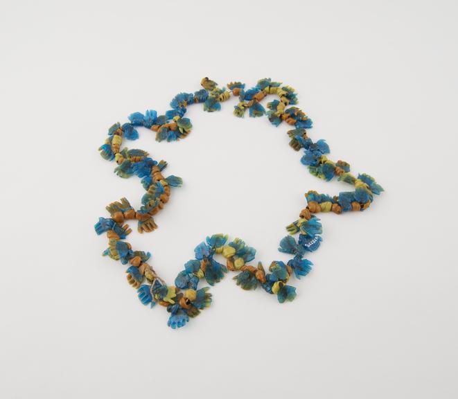 96 crudely executed and stylised glass hands threaded on string ...