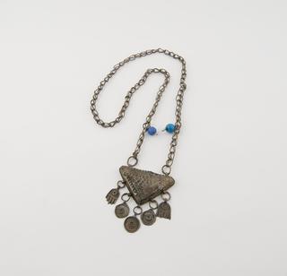 Triangular metal amulet | Science Museum Group Collection