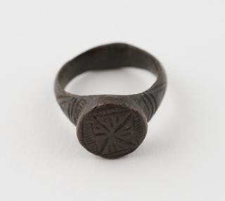 Metal finger ring with circular bezel bearing cabalistic signs ...