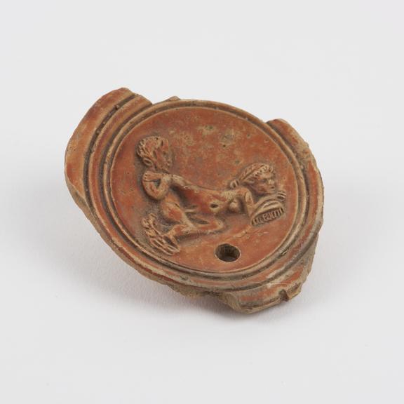 Broken terracotta lamp cover with moulded design of copulating couple ...