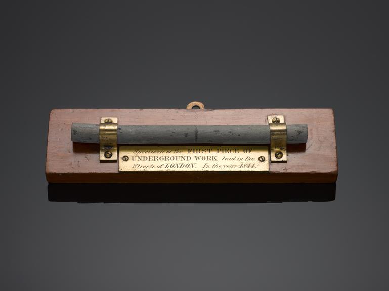 Section, of first London underground cable, on wood mount with a brass ...