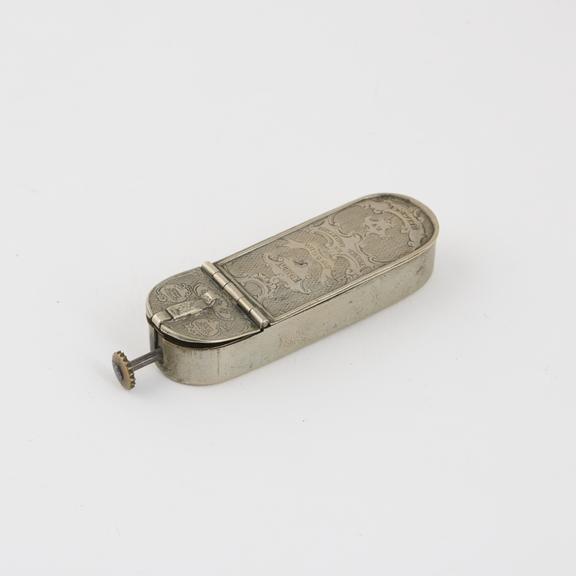 A Lighter in form of a neat box (length 2 1/4 ins) of white-metal ...
