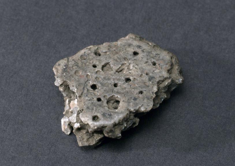 Soft pitted grey stone carried to protect against toothache | Science ...