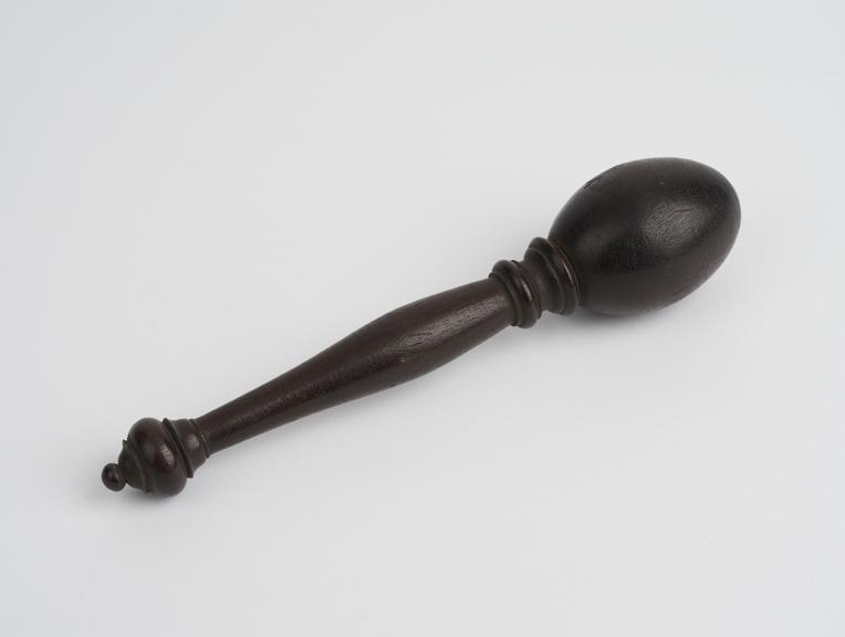 Small wooden pestle with turned handle and rounded grinding end ...